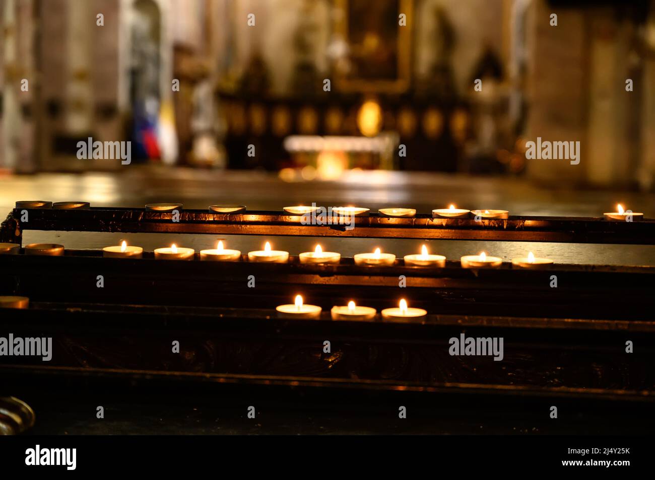 Lampion candles glowing in a dark church. Emotional mood Stock Photo ...