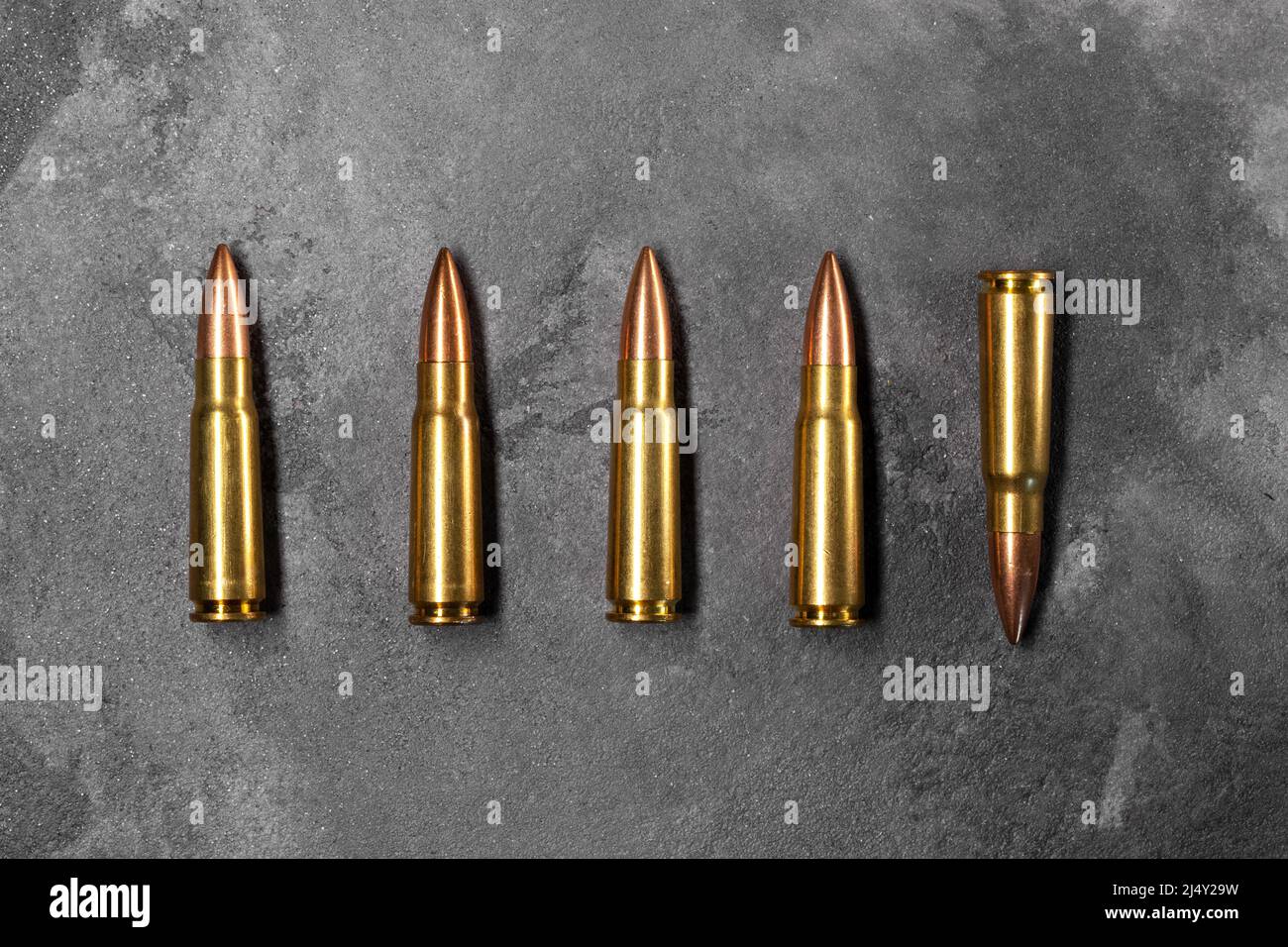 Bullets on gray background. One bullet positioned in opposite direction ...