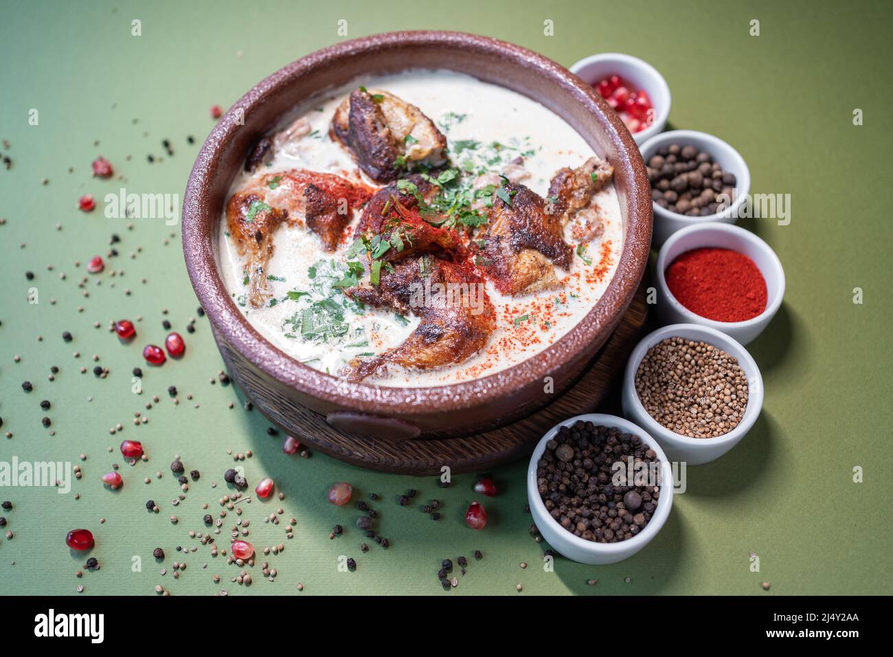 traditional georgian chkmeruli chiken meat in cream sauce in clay bowl ...
