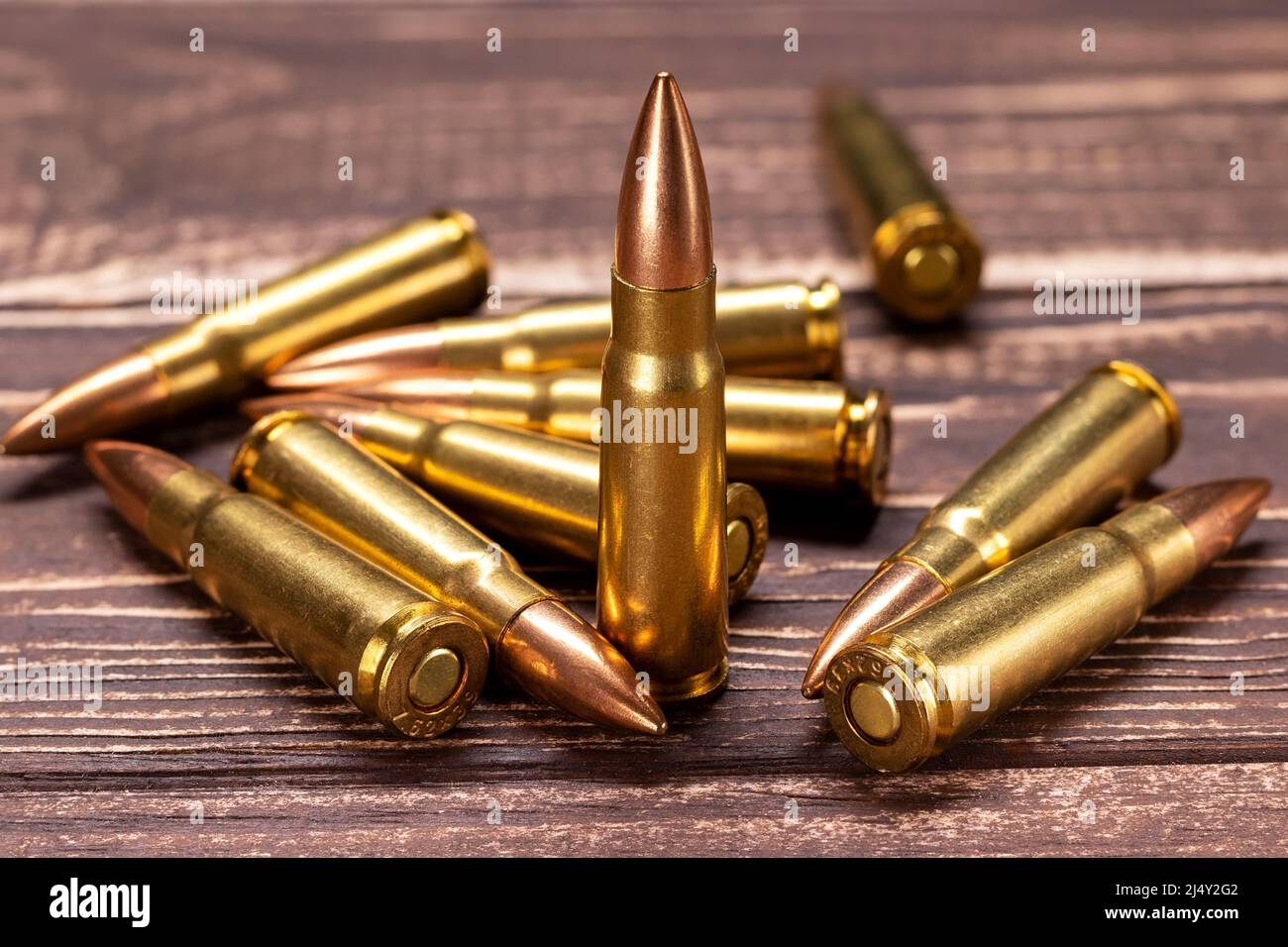 Bullets on wooden background. Cartridges 7.62 caliber for ak 47 closeup ...