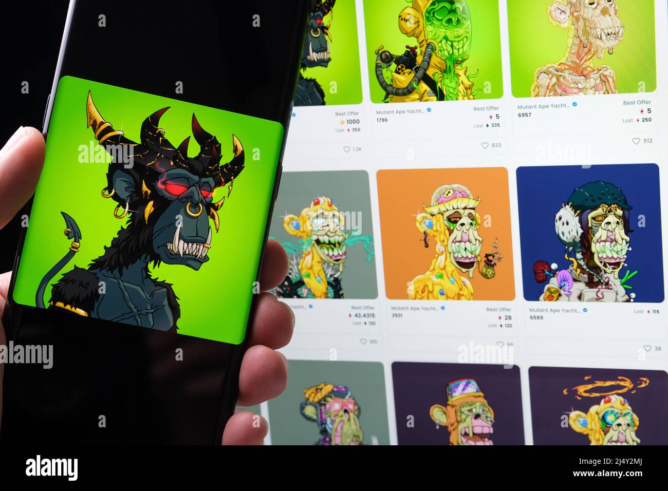 MUTANT APE NFT 4849 seen on the silhouette of smartphone and some other ...