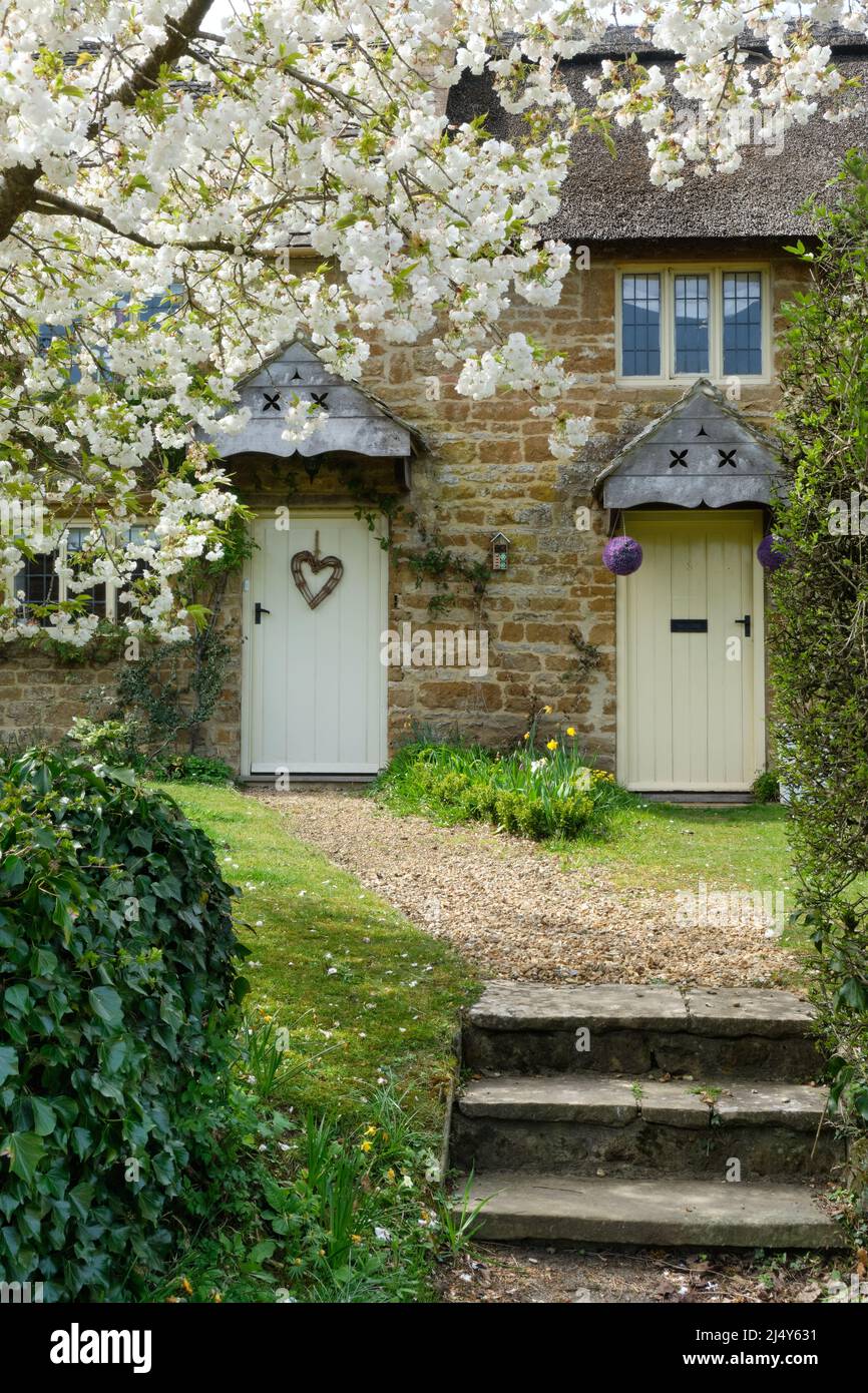 Spring view of cottage doorways Great Tew Oxfordshire Stock Photo - Alamy