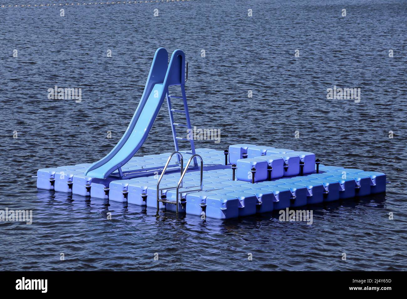 plastic bathing platform with a slide in the lake Stock Photo - Alamy