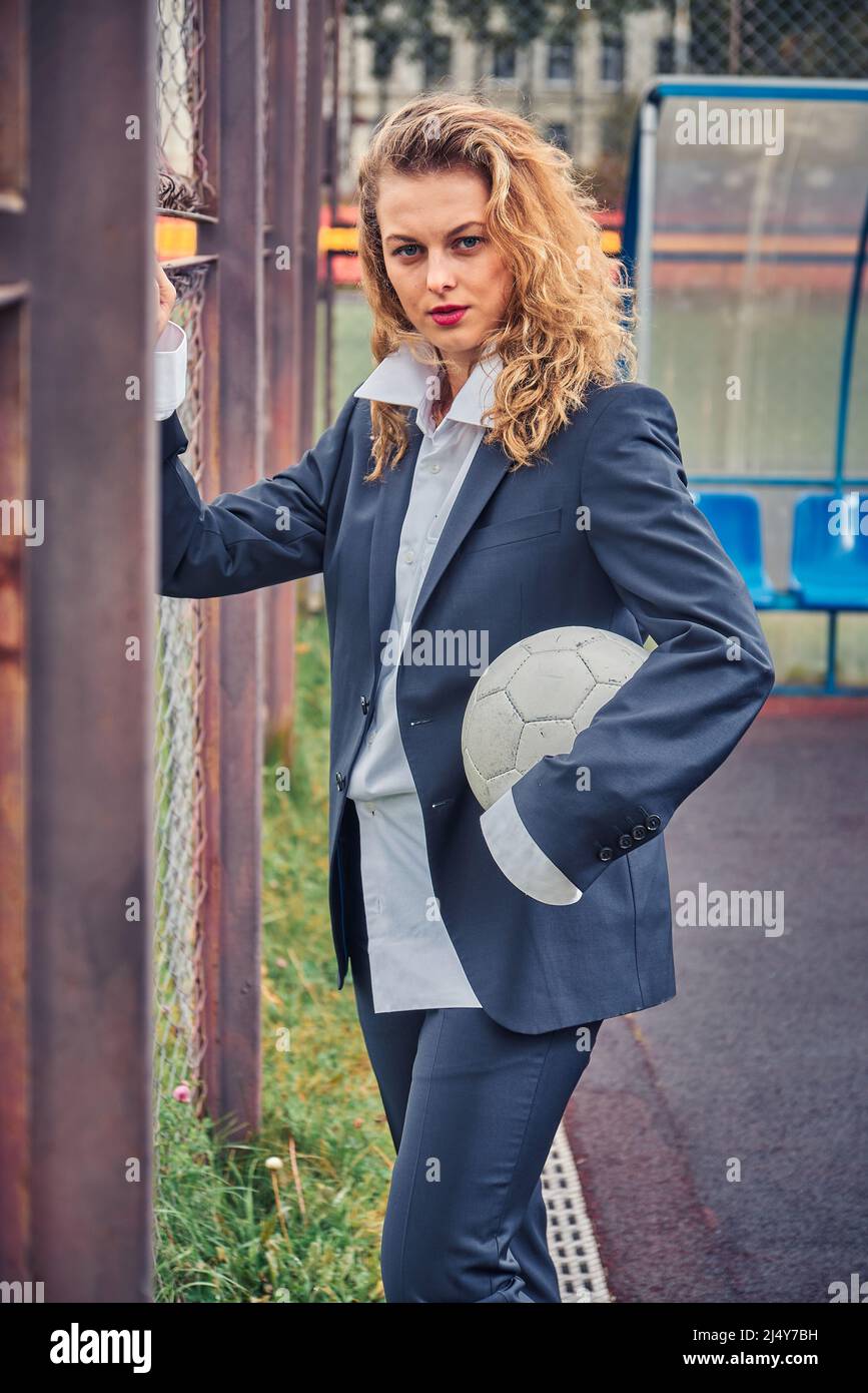 portrait of female soccer coach with ball at the stadium Stock Photo ...