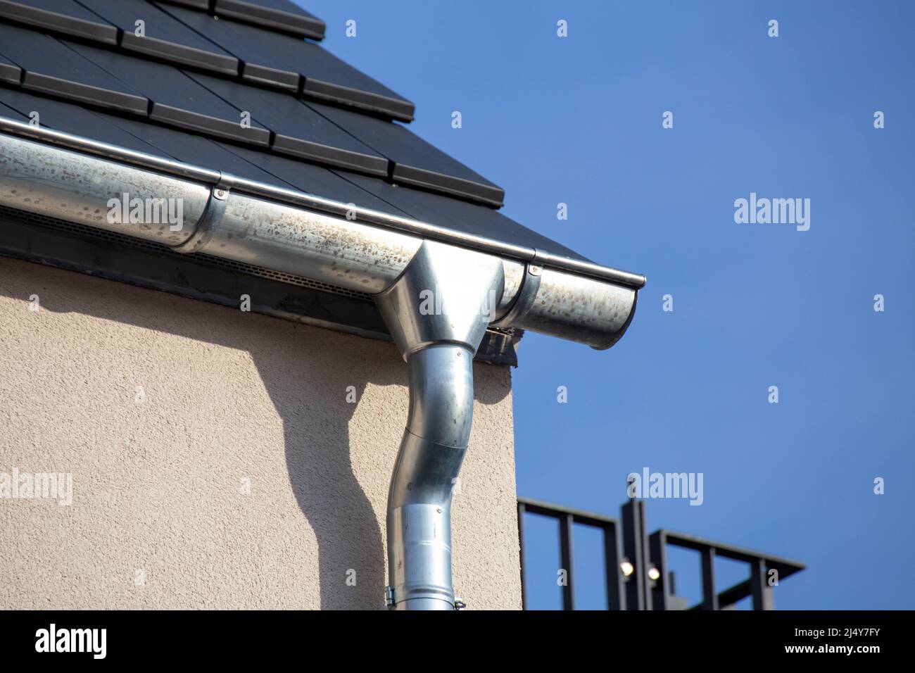 Roof gutter on a new tiled roof Stock Photo - Alamy