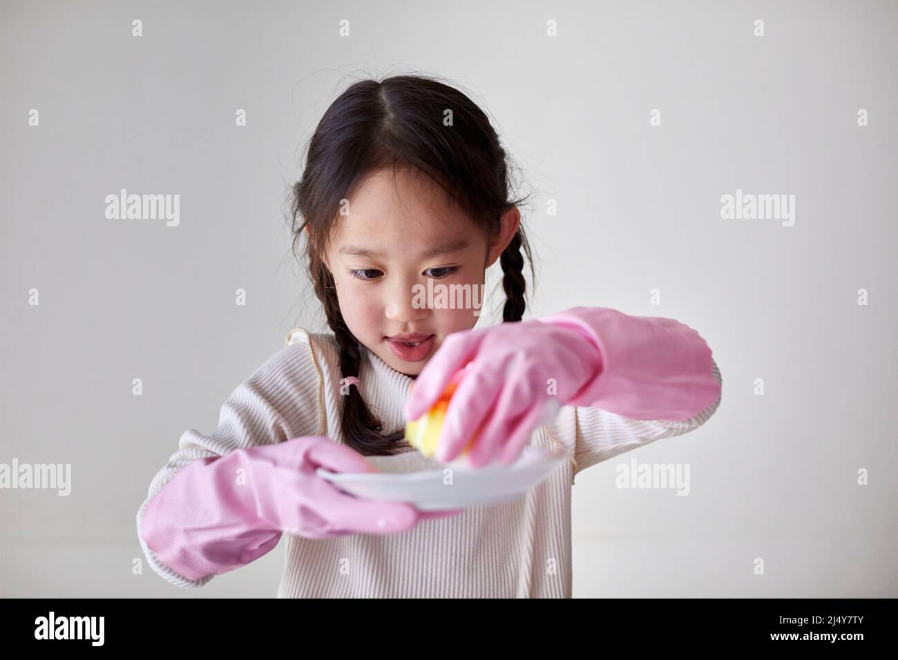 Japanese kid washing dishes at home Stock Photo - Alamy