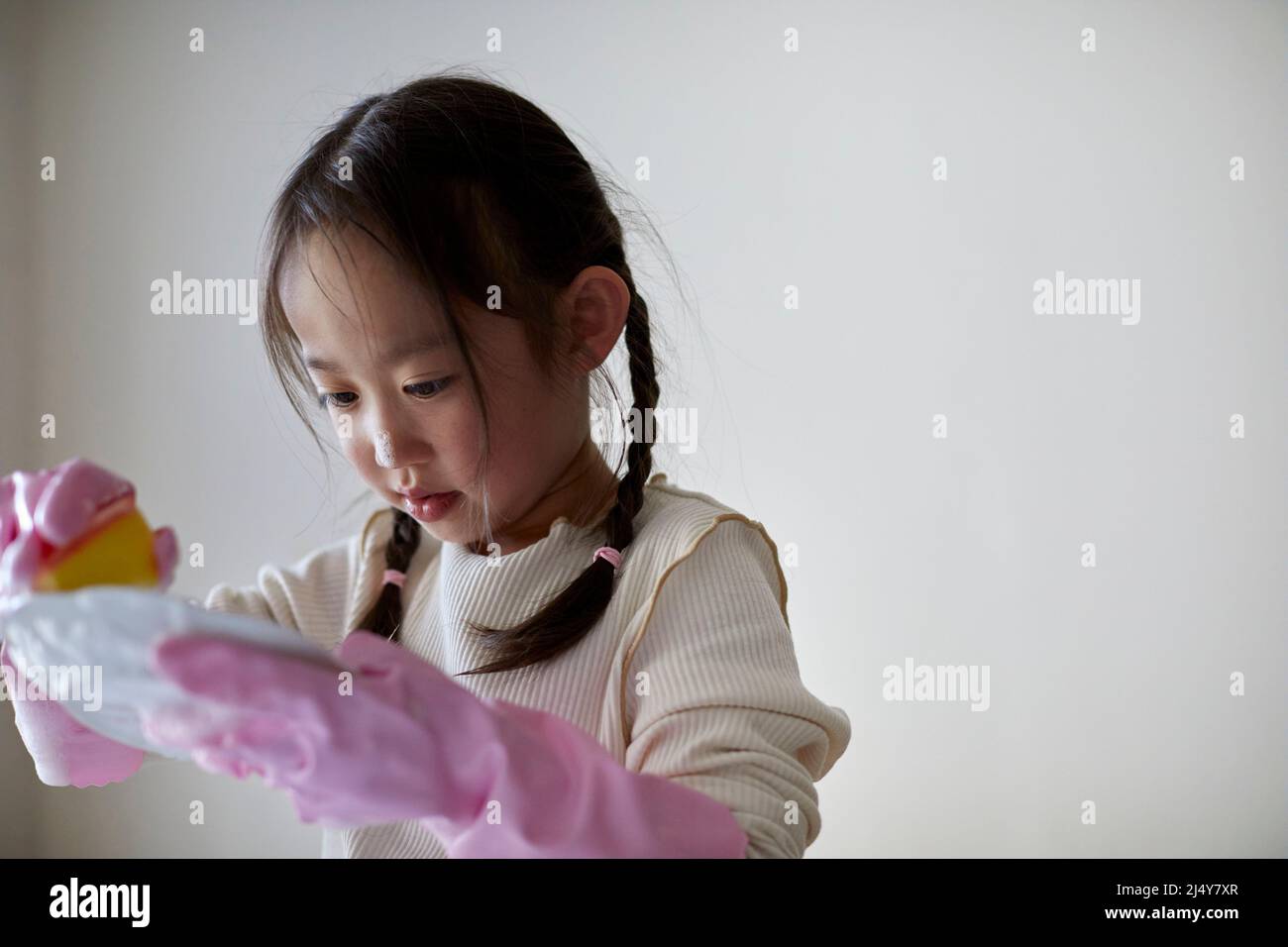 Japanese kid washing dishes at home Stock Photo - Alamy