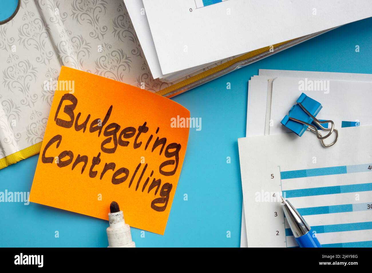 Open big folder and budgeting controlling sign Stock Photo - Alamy