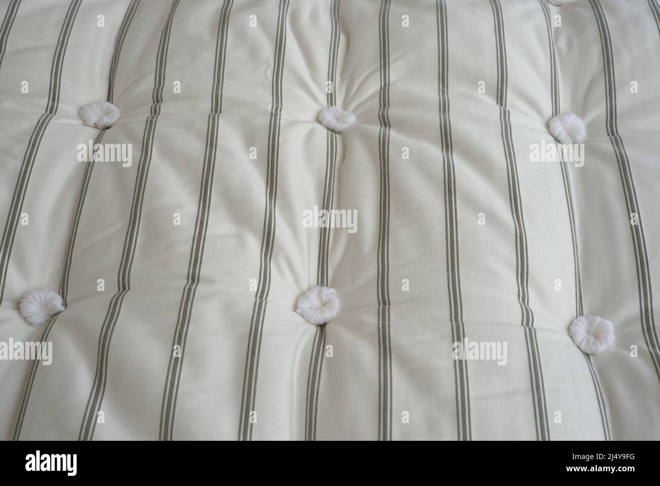 A mattress tuft to keep all the layers together. Tufting on a mattress ...