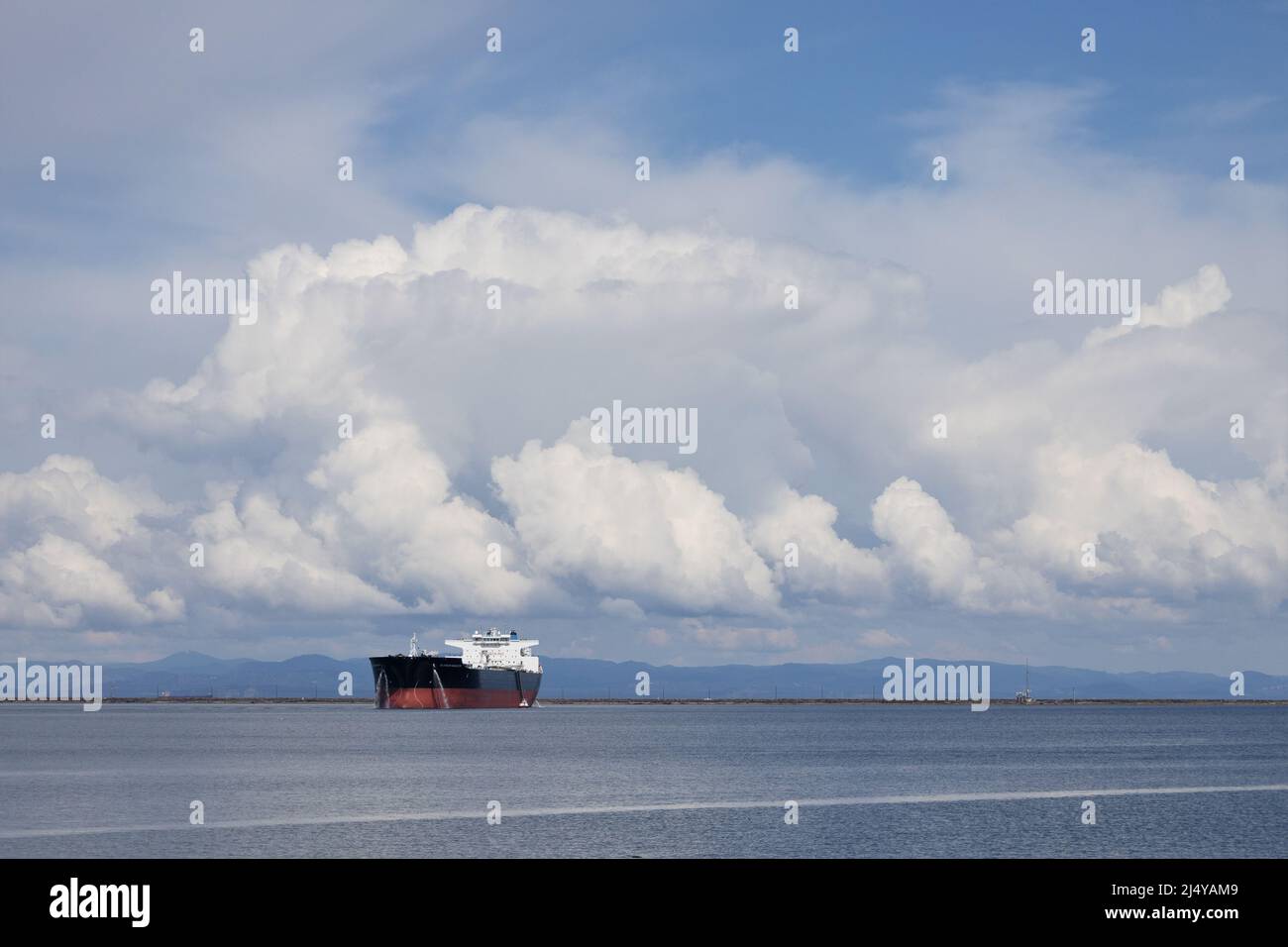 Alaskan Navigator, a crude oil tanker, under a large storm cloud in ...