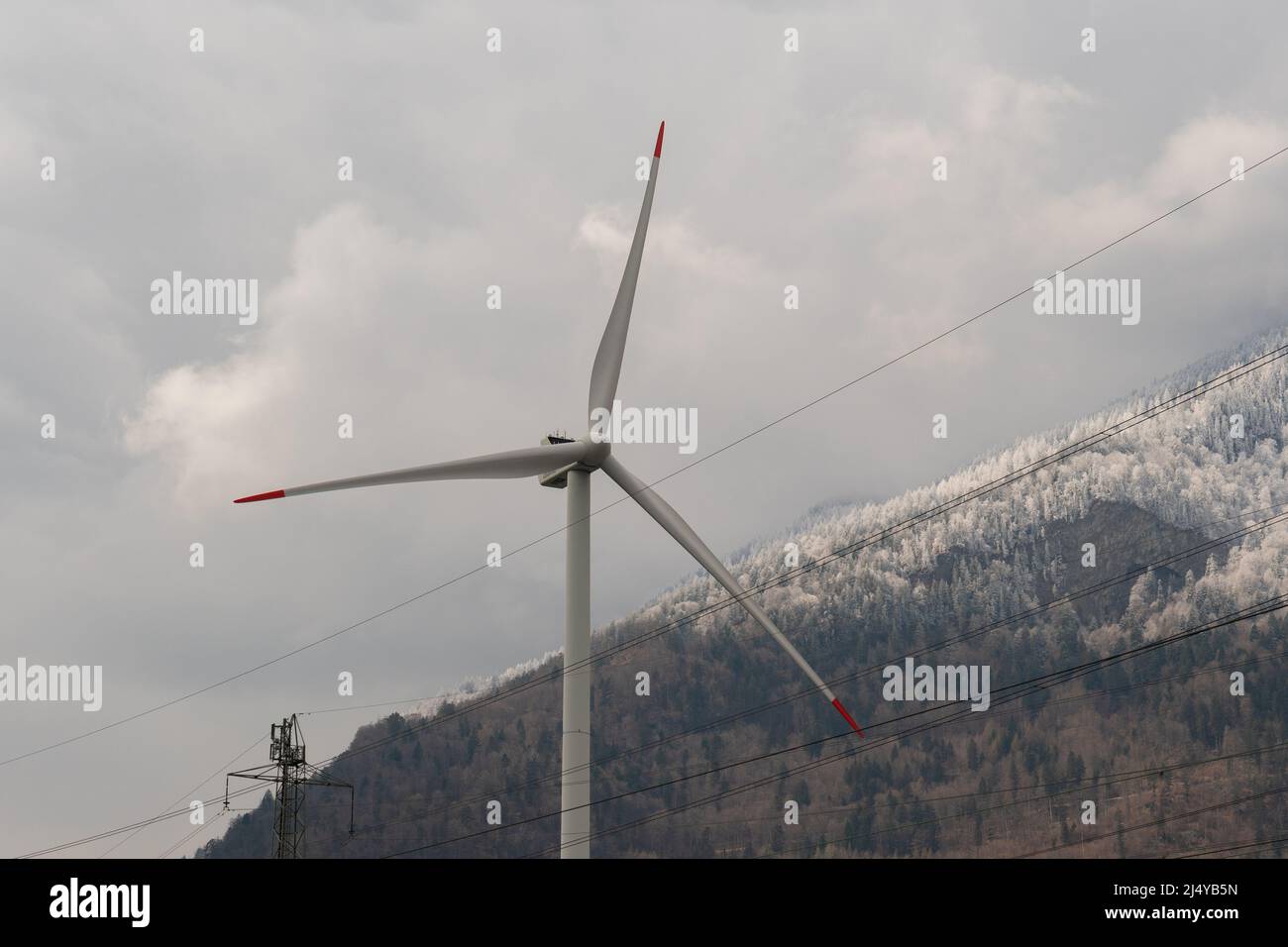 Chur, Switzerland, April 3, 2022 Windmill in front of the snow covered ...