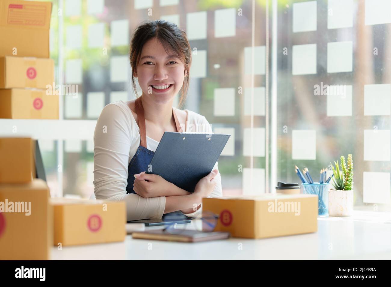 Asian small business owner working at home office. Business retail ...