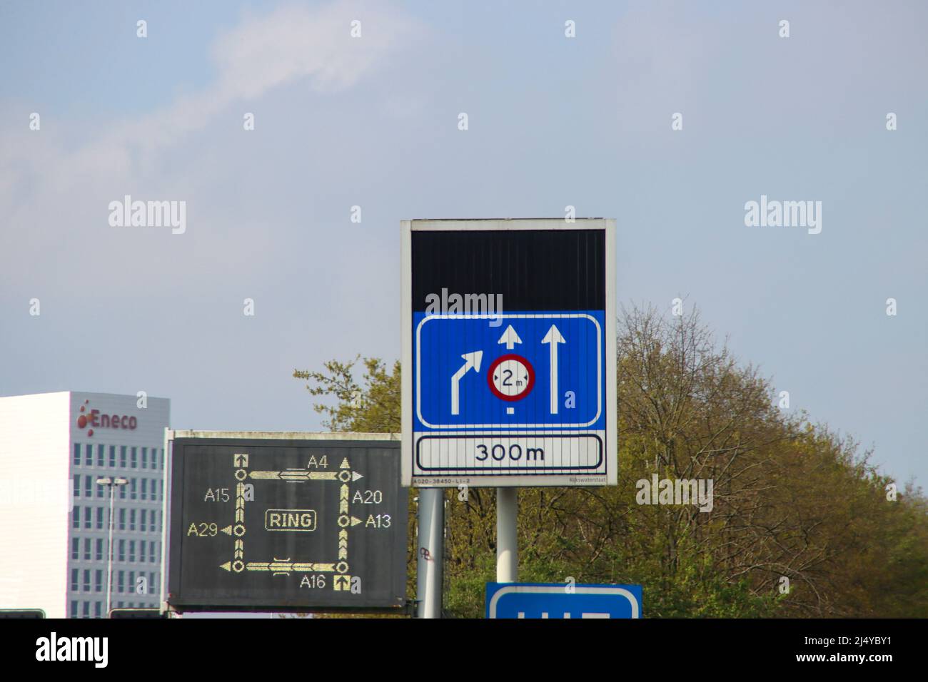 Blue information sign for the directions on Motorway A20 merging from 3 ...