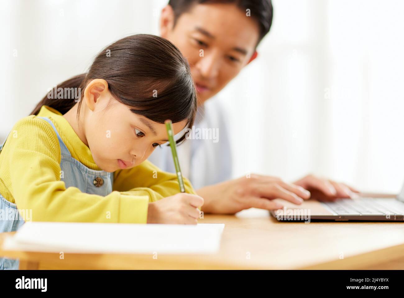 Japanese kid studying at home with her parents Stock Photo - Alamy