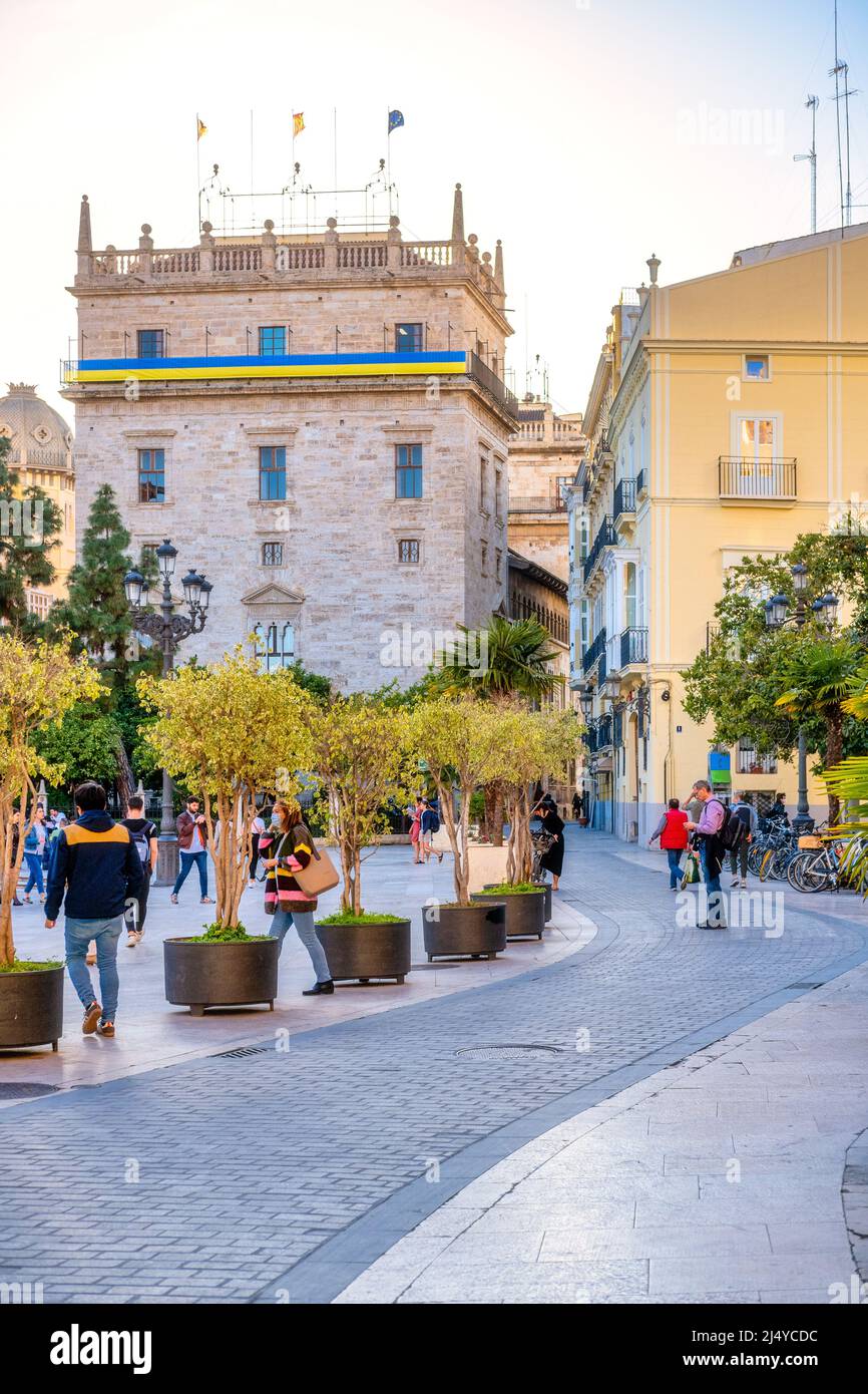 Tourists in the Virgin's Plaza. A narrow cobblestone street leads to ...