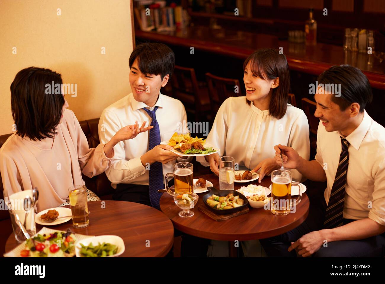 Japanese businesspeople having drinks and dining at a bar Stock Photo ...
