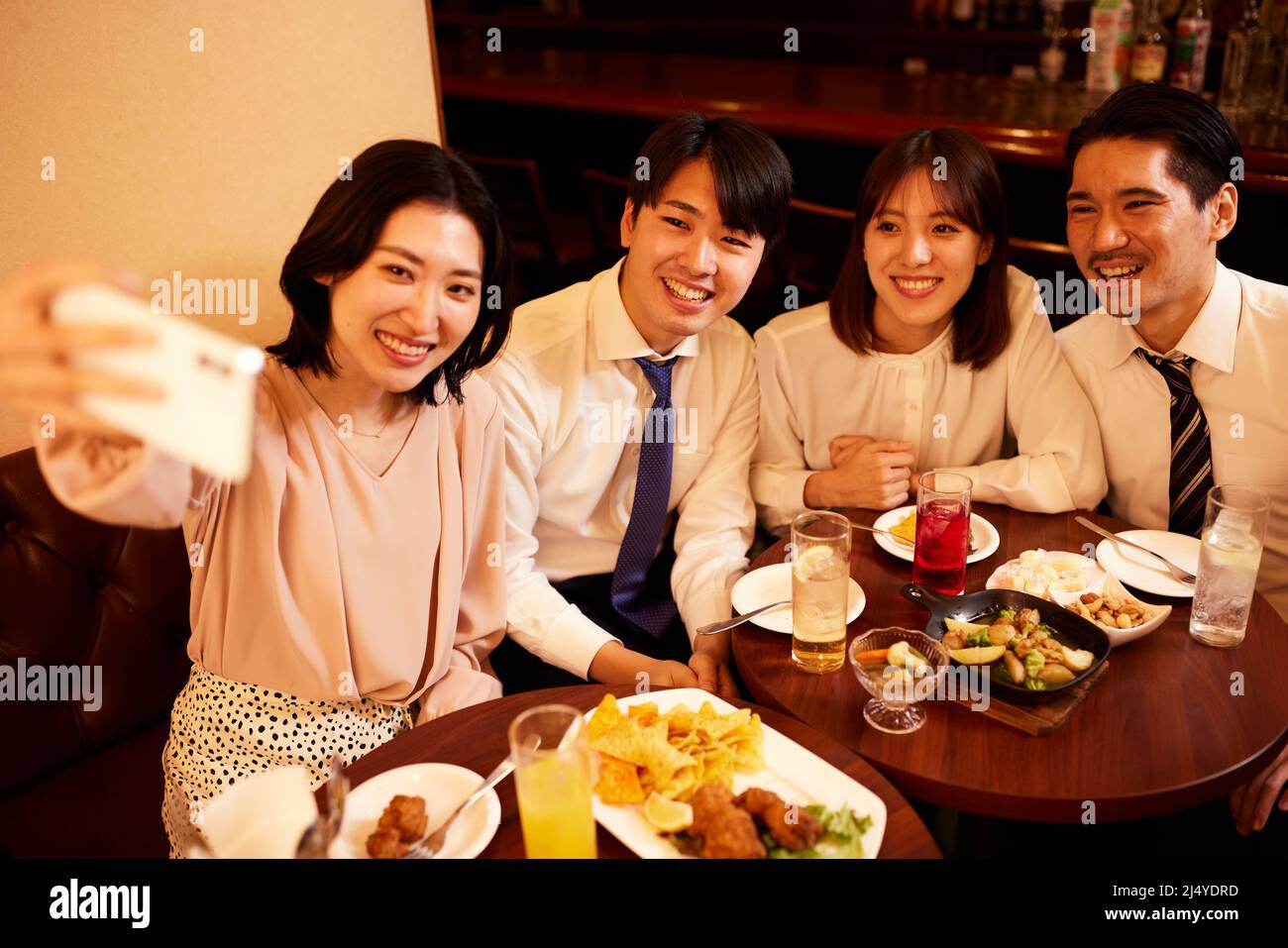 Japanese businesspeople having drinks and dining at a bar Stock Photo ...