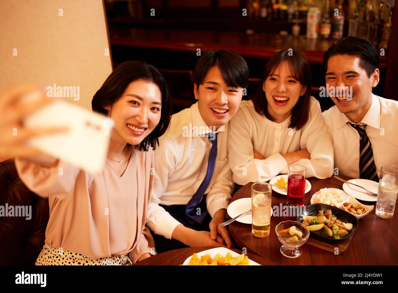 Japanese businesspeople having drinks and dining at a bar Stock Photo ...