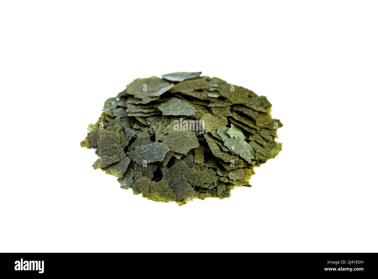 Dry handful, bunch green flakes compound fish feed flakes on White ...