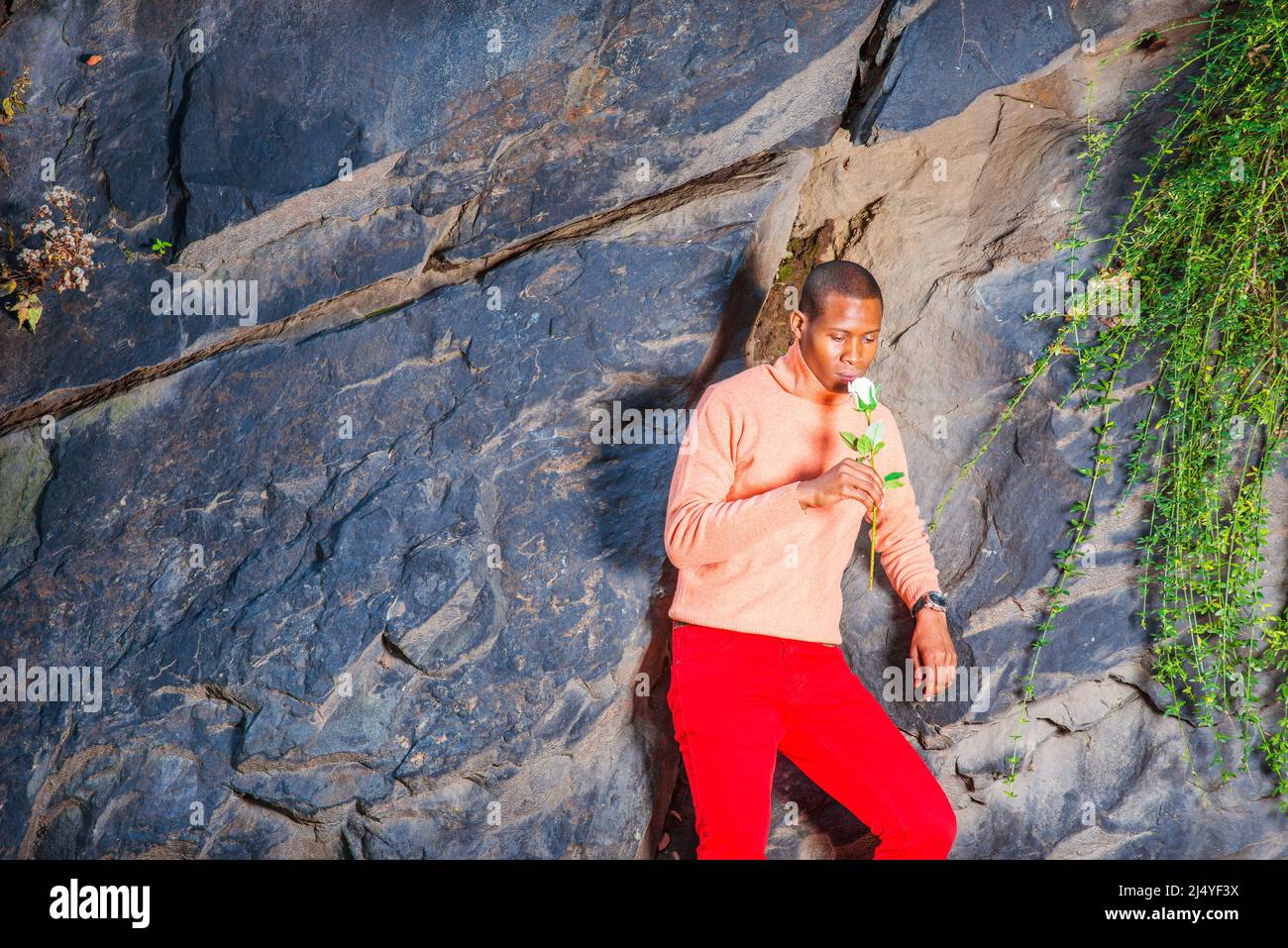 Man Missing You. Dressing in light orange sweater with high collar, red ...