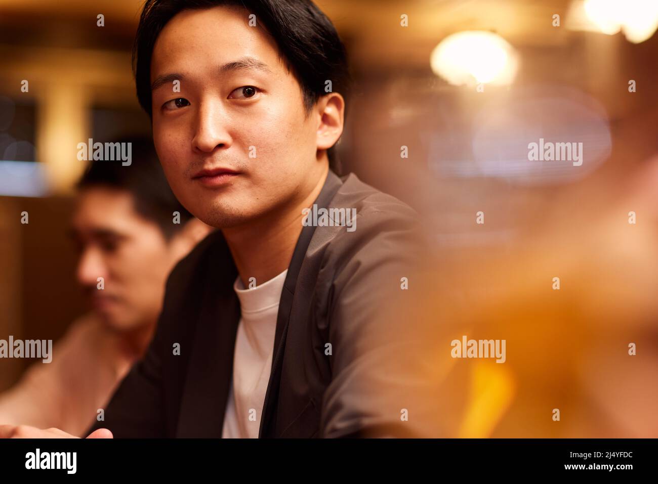 Japanese friends having a drink at a bar counter Stock Photo - Alamy