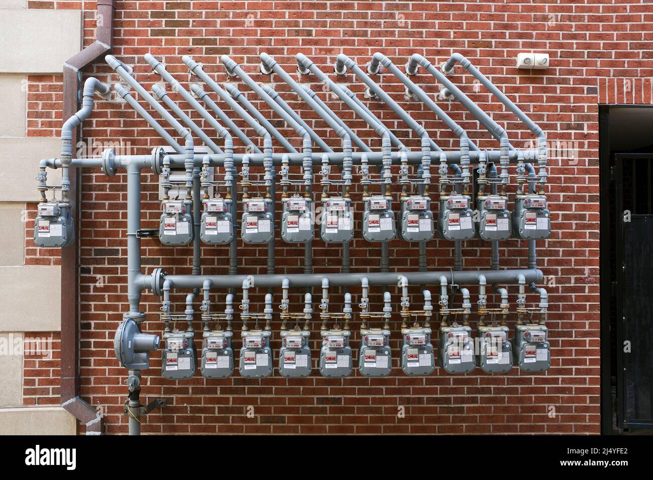 Two Rows of Utility Meters against Brick Wall Stock Photo - Alamy