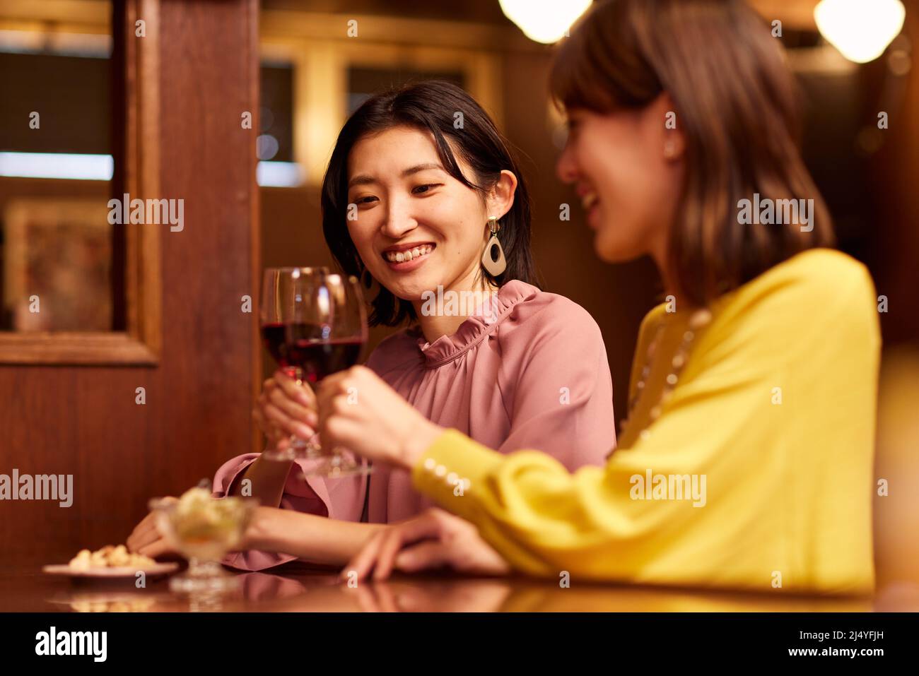 Japanese friends having a drink at a bar counter Stock Photo - Alamy