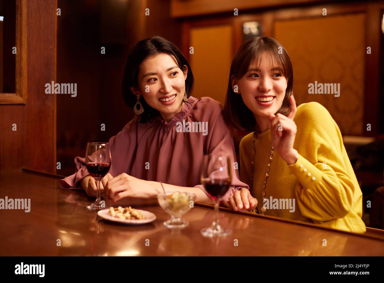Japanese friends having a drink at a bar counter Stock Photo - Alamy