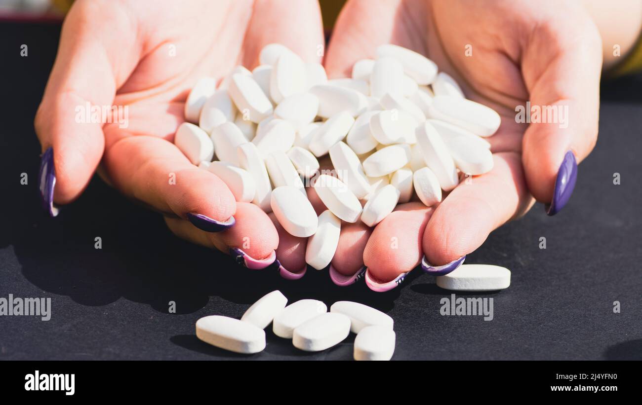 Pills in womens hands hi-res stock photography and images - Alamy
