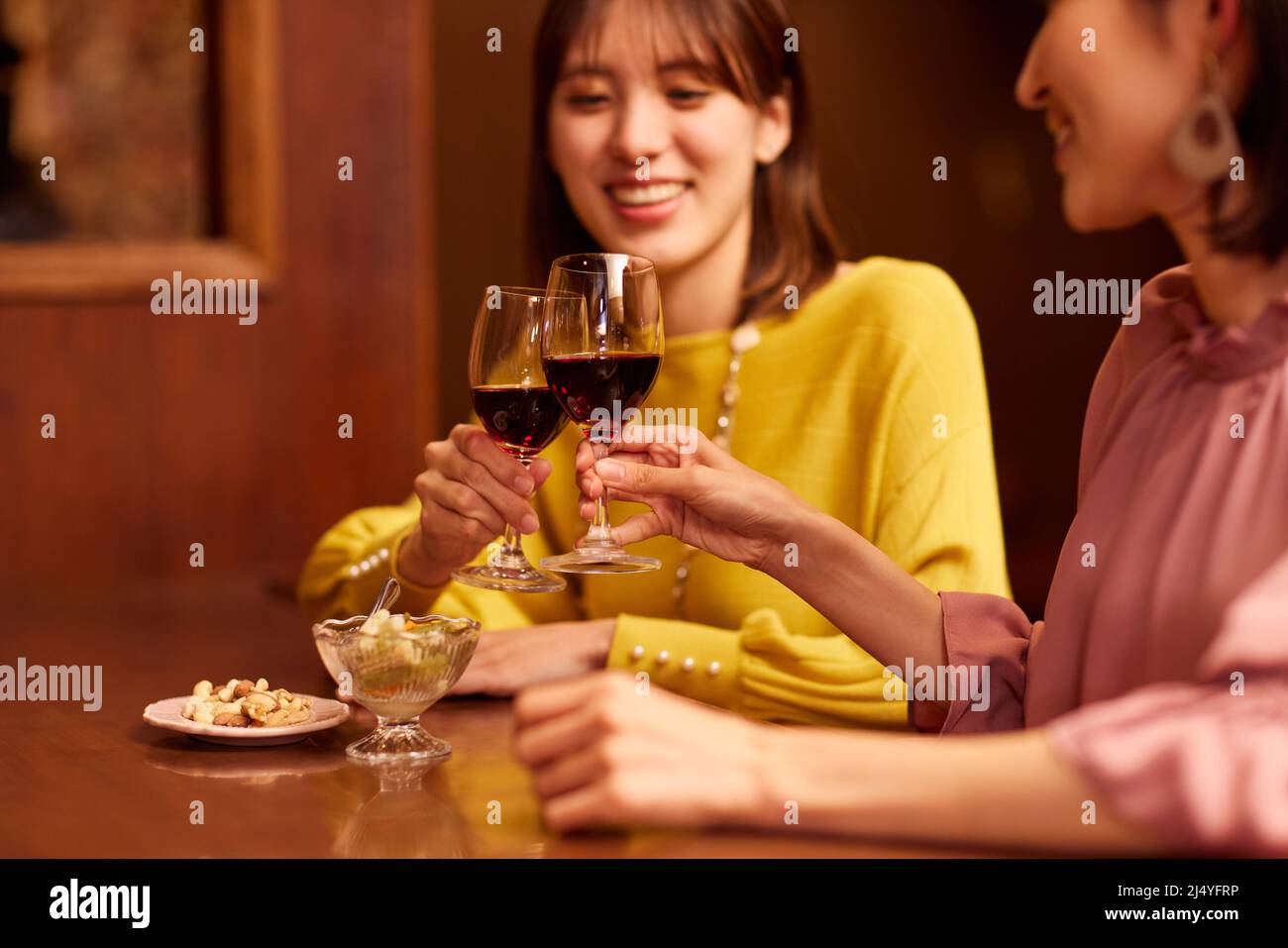 Japanese friends having a drink at a bar counter Stock Photo - Alamy