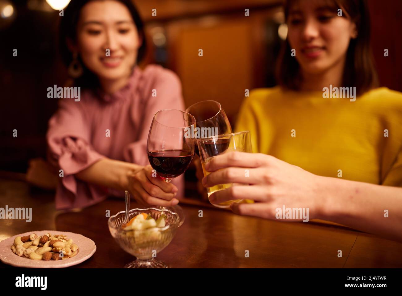Japanese friends having a drink at a bar counter Stock Photo - Alamy