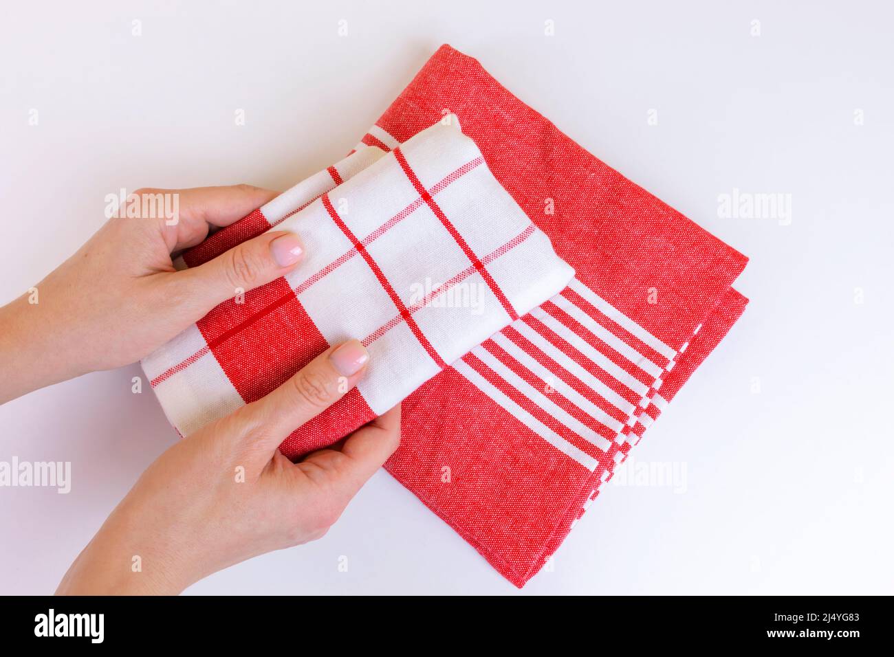 Woman holding new red checkered kitchen towels. Cooking, cleaning ...