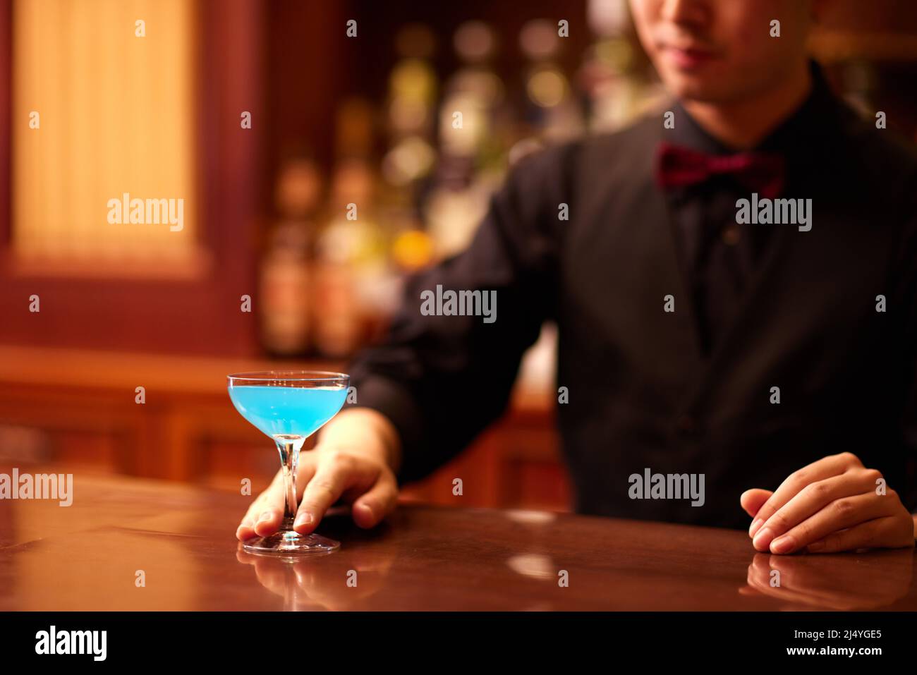 Japanese bartender serving a drink Stock Photo - Alamy