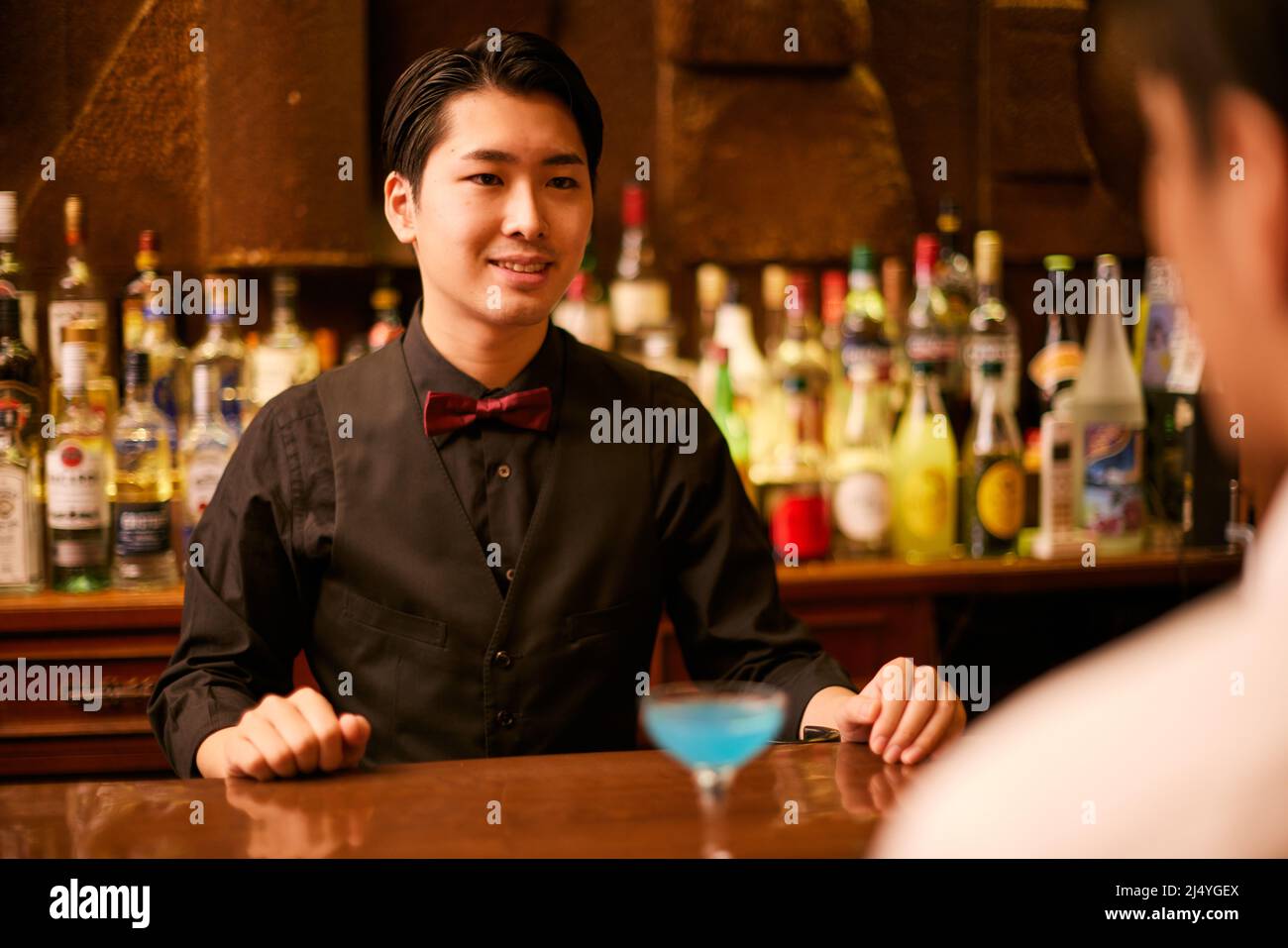 Japanese bartender serving a drink Stock Photo - Alamy