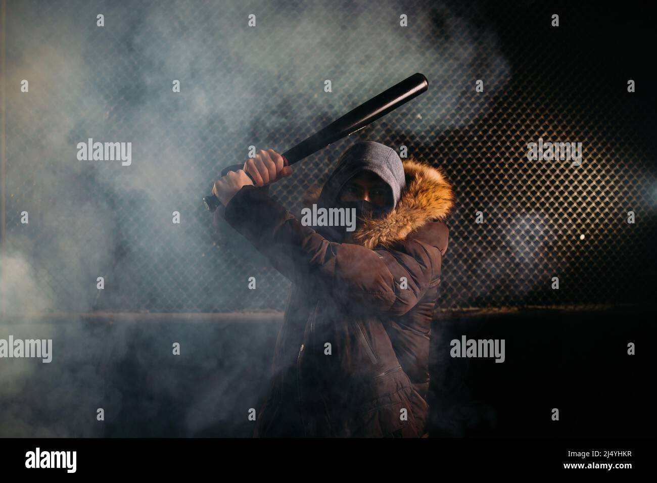 Masked angry man with bat in smoke Stock Photo - Alamy