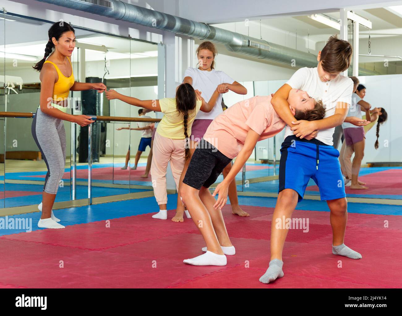 Kids in pair exercising self-defense movements Stock Photo - Alamy