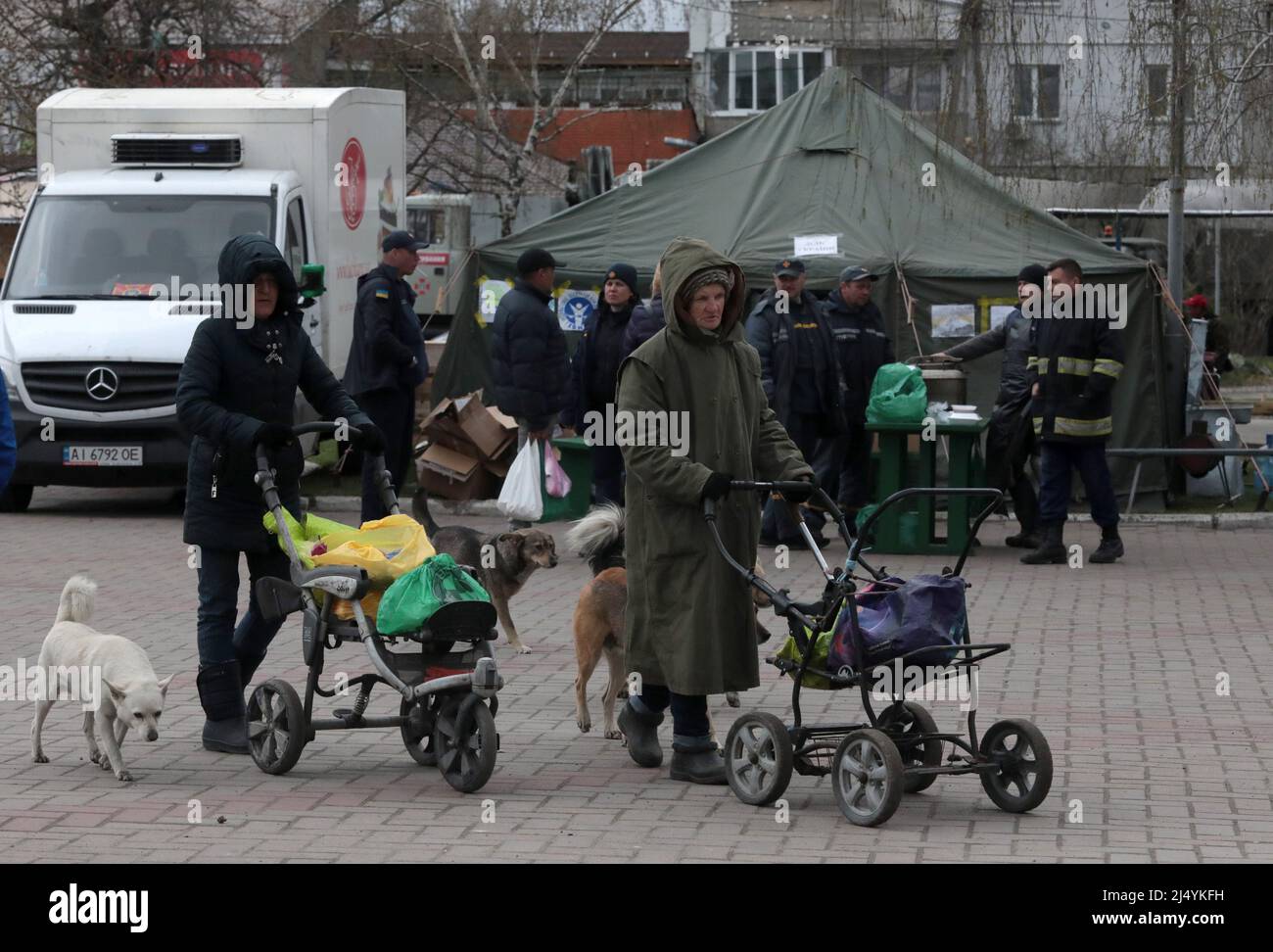 BORODIANKA, UKRAINE - APRIL 16, 2022 - Two elderly women surrounded by ...
