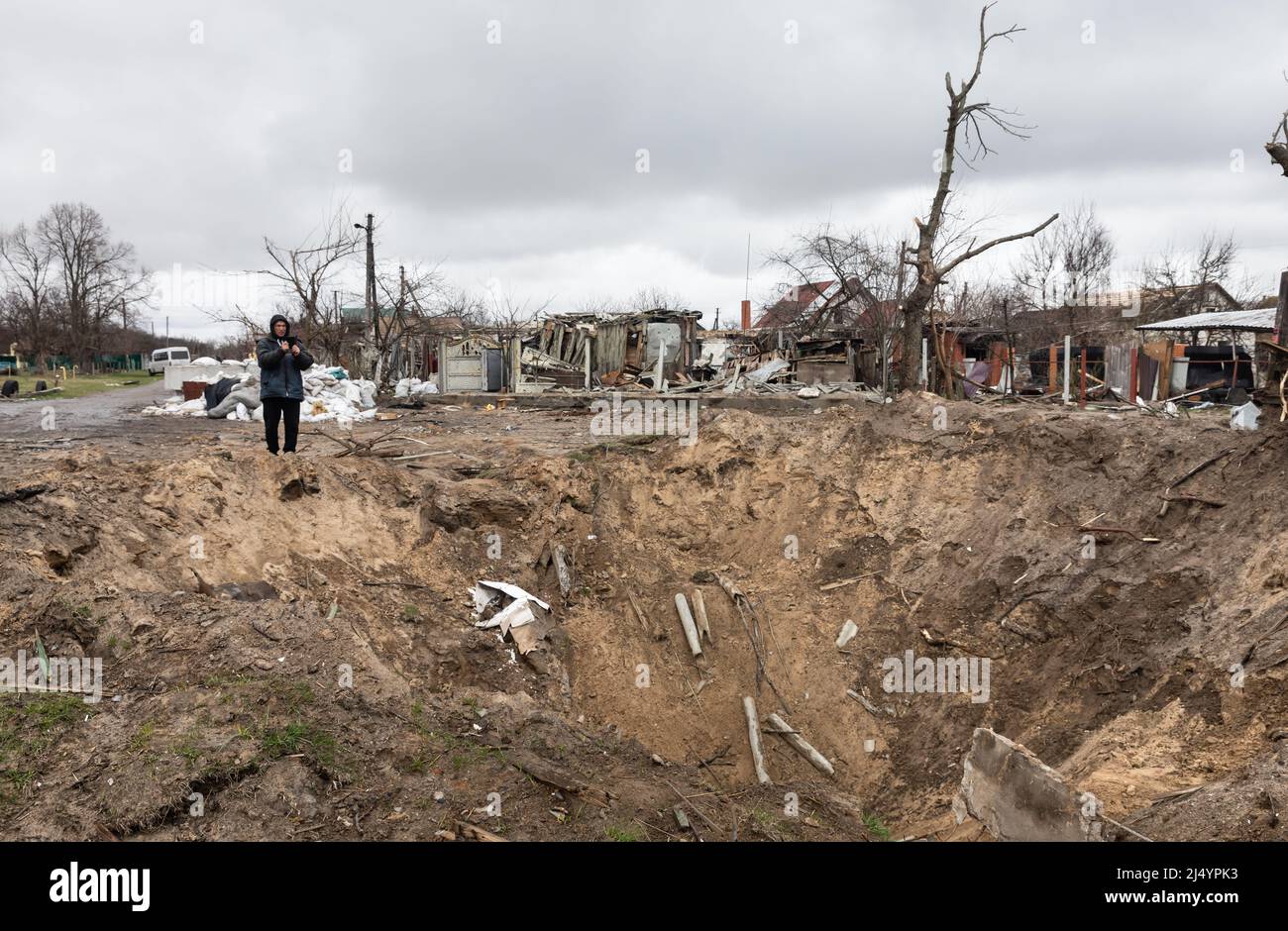 Chernihiv, Ukraine. 17th Apr, 2022. A man photographs a crater from a ...