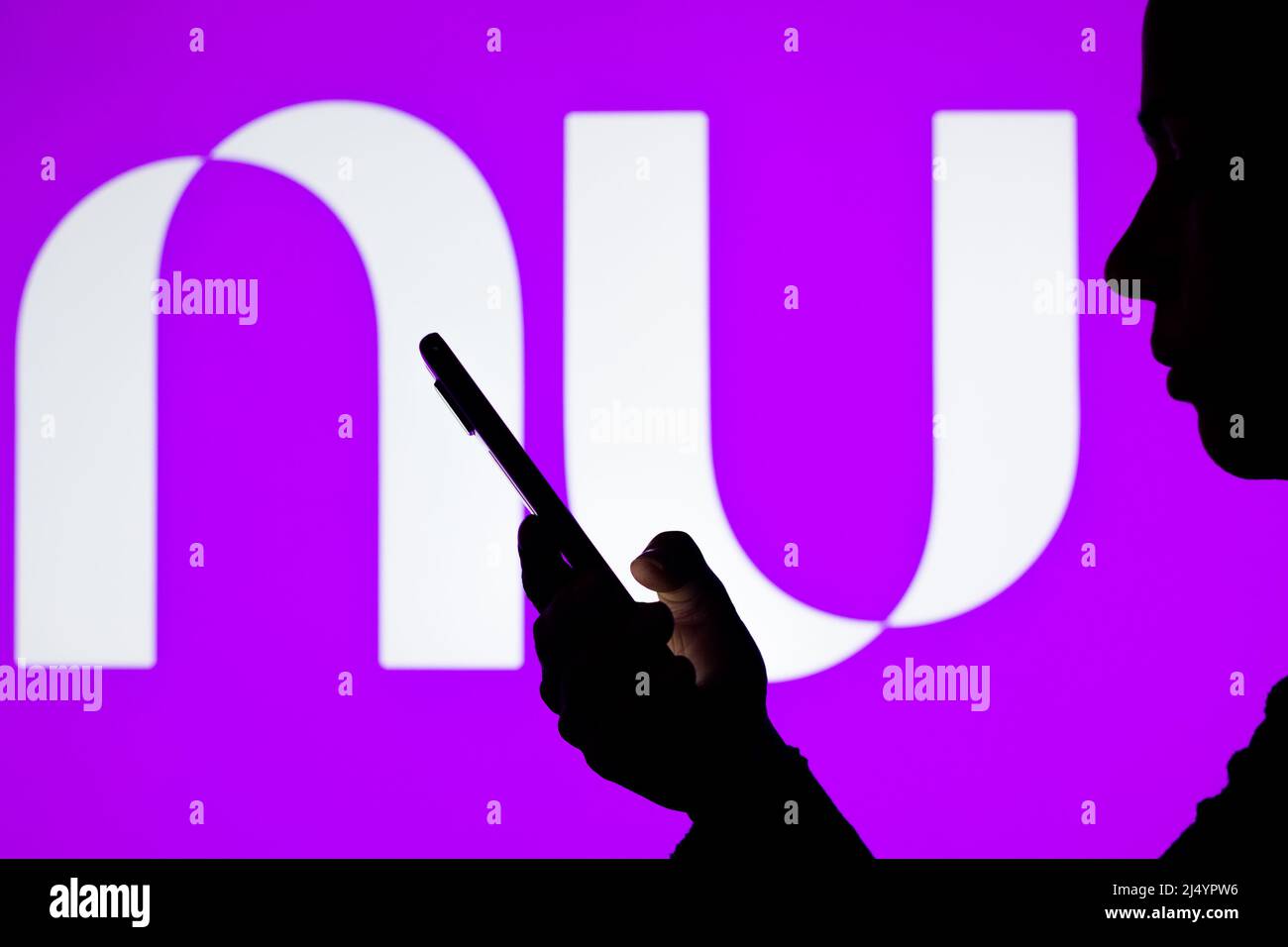 In this photo illustration the Nubank logo seen in the background of a ...