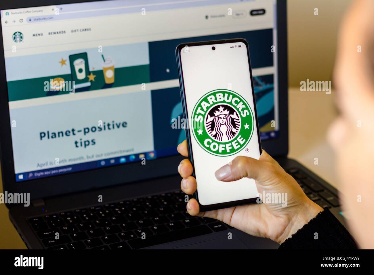 In this photo illustration, a woman holds a smartphone with the ...