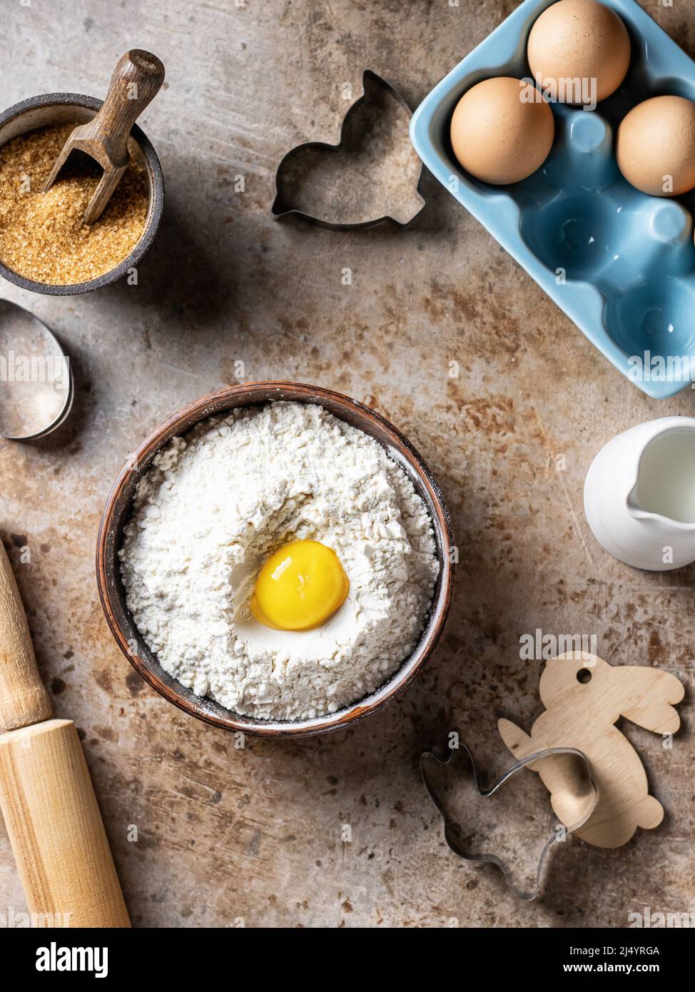The process of baking, cooking flat lay. Flour in bowl with the egg ...