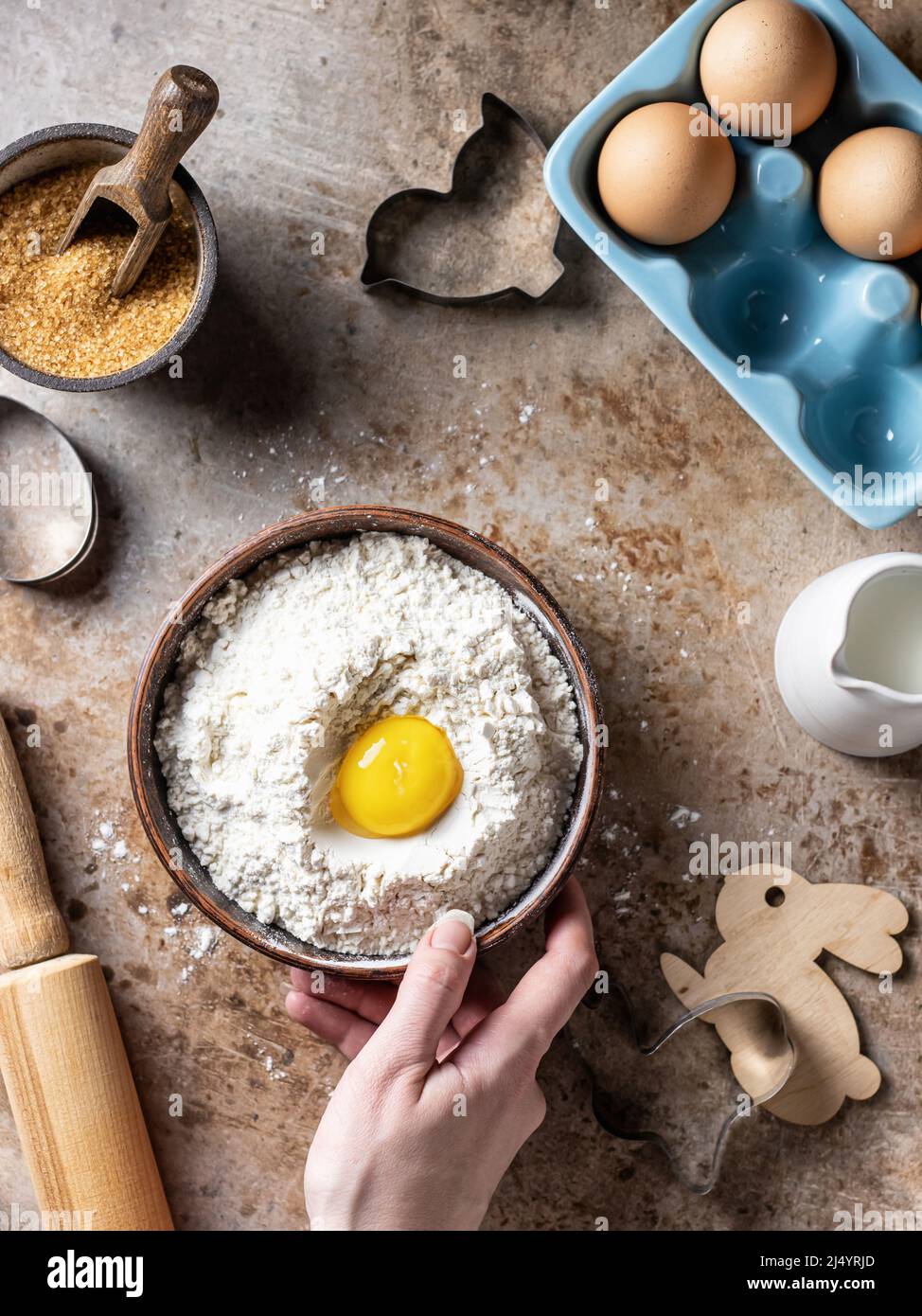 The process of baking, cooking flat lay. Flour in bowl with the egg ...