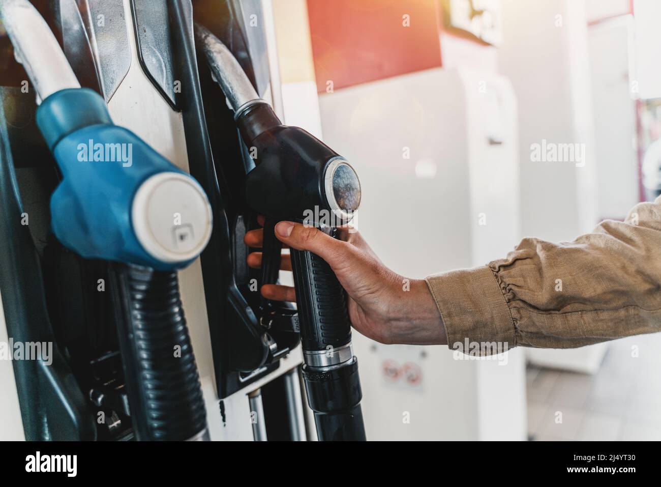 Fuel pump fill a tank of a car in a station Stock Photo - Alamy