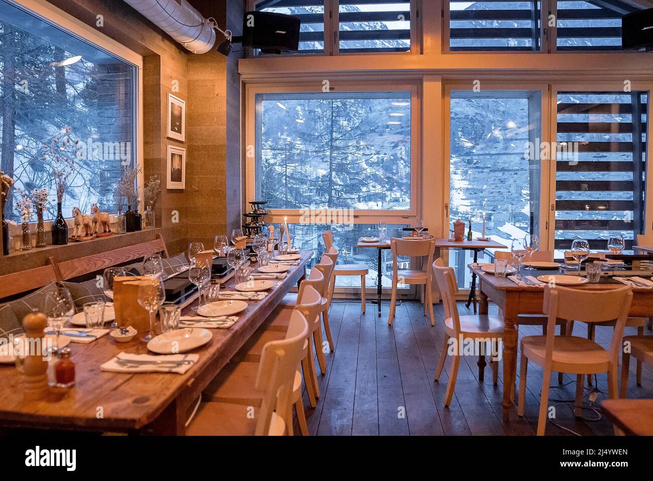 Modern interior of dining area with view of mountain at luxurious ski ...