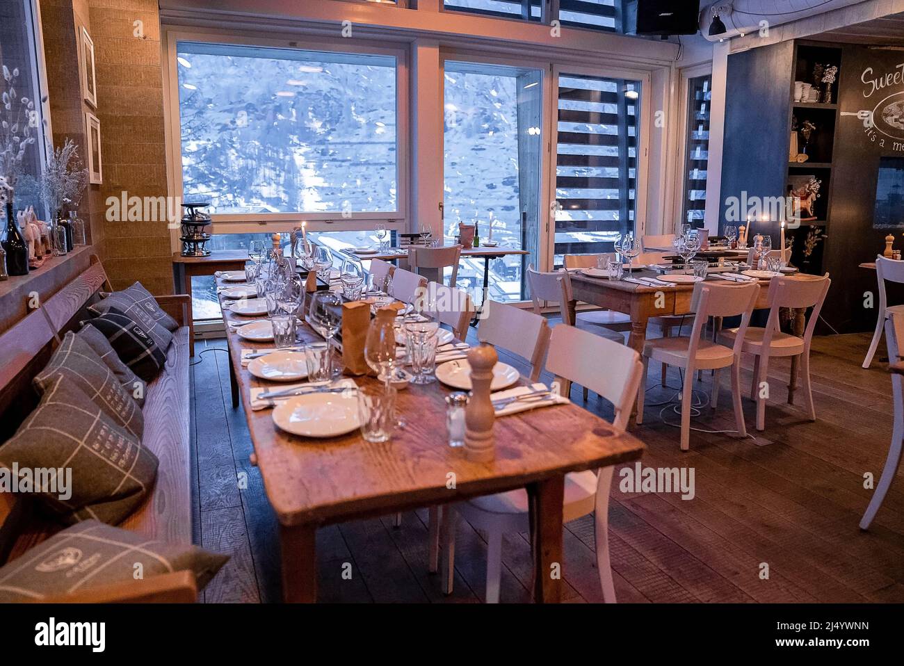 Interior of restaurant with mountain view in window at luxurious resort ...