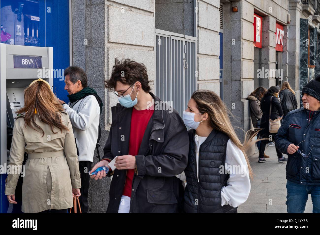 Customers are withdrawing money from an ATM machine at the Spanish ...