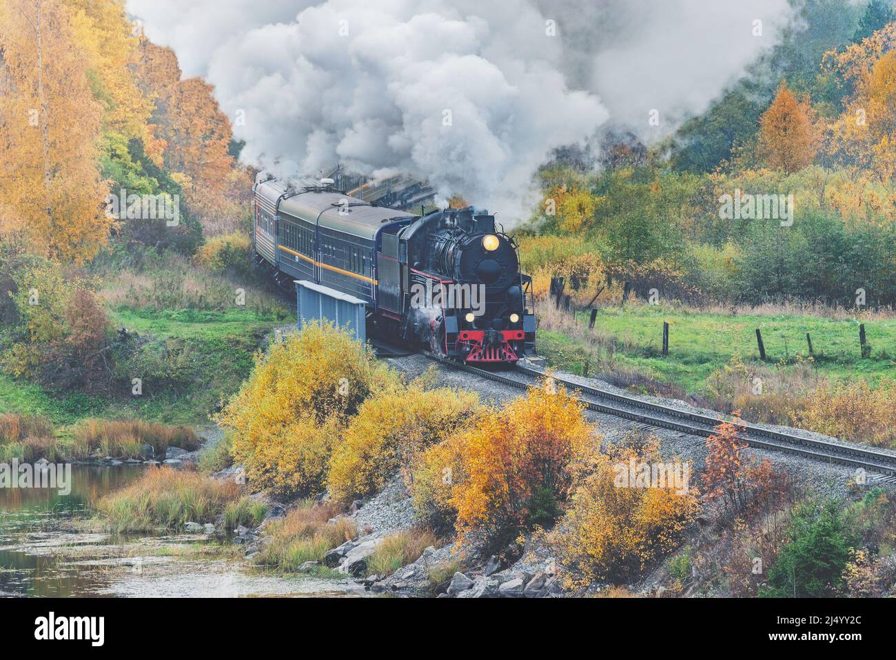 Retro steam train moves at autumn morning Stock Photo - Alamy