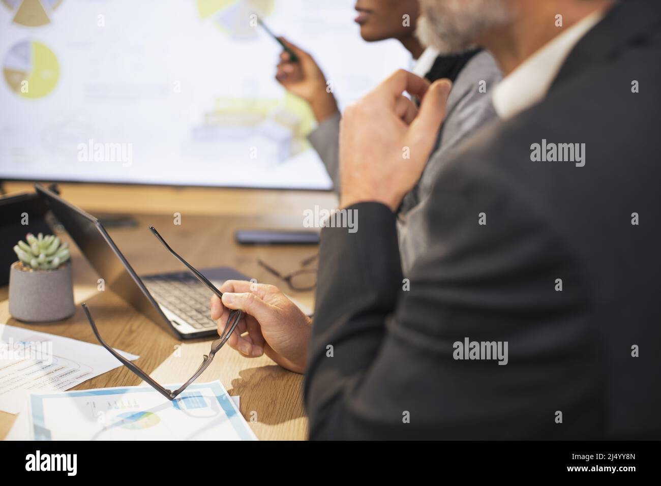 Teamwork, brainstorming in office. Focus on papers with financial carts ...