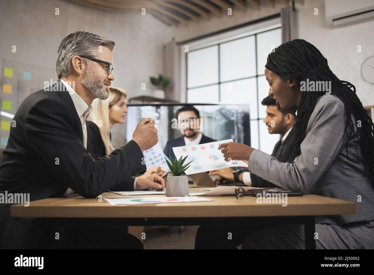 Concentrated diverse businesspeople, having telemeeting at office in ...