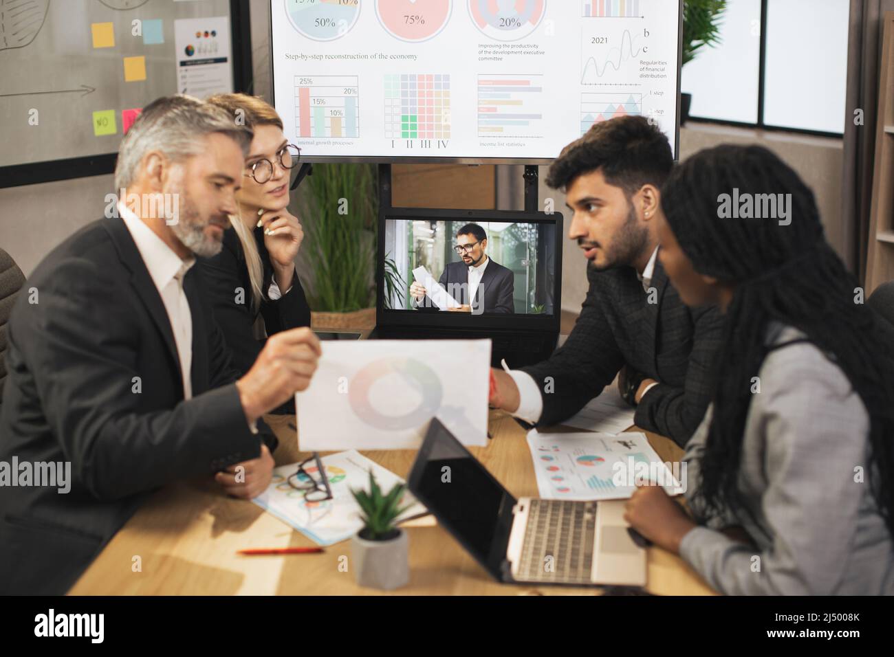 Electronic meeting concept. Diverse group of multiracial business people in the conference room ...